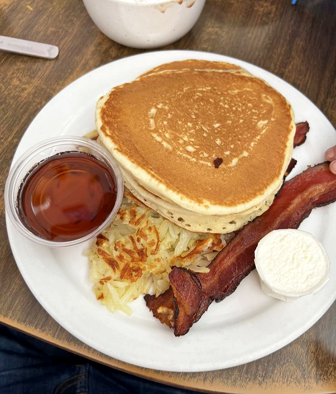 Golden pancakes, crispy bacon, and hash browns that could make a grown adult weep with joy. Breakfast doesn't get more perfect than this.