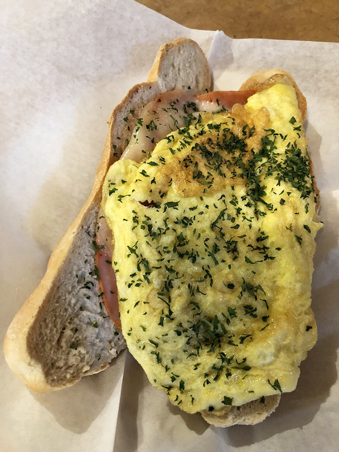 Breakfast sandwich perfection doesn't exi&mdash; Oh wait, it does. Fresh herbs sprinkled over fluffy eggs on house-made bread creates morning magic that puts your sad toaster to shame. 