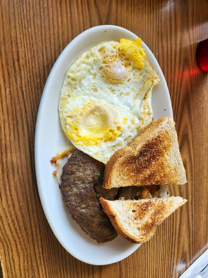 Breakfast perfection doesn't need fancy plating&mdash;just a sunny-side egg, perfectly browned sausage, and toast that's actually toasted right.