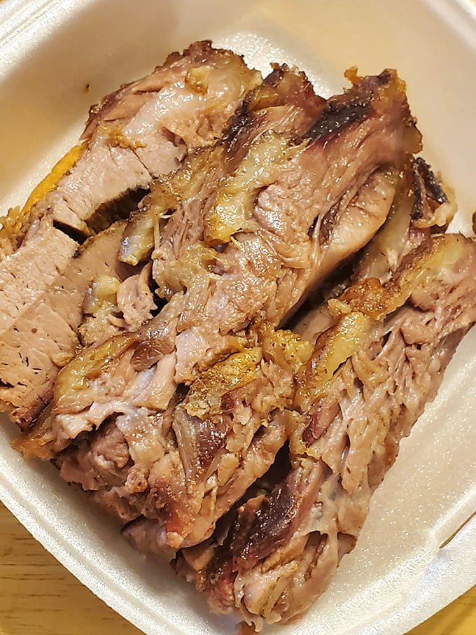 Behold the brisket in all its glory&mdash;tender, pink-ringed perfection that makes vegetarians question their life choices.