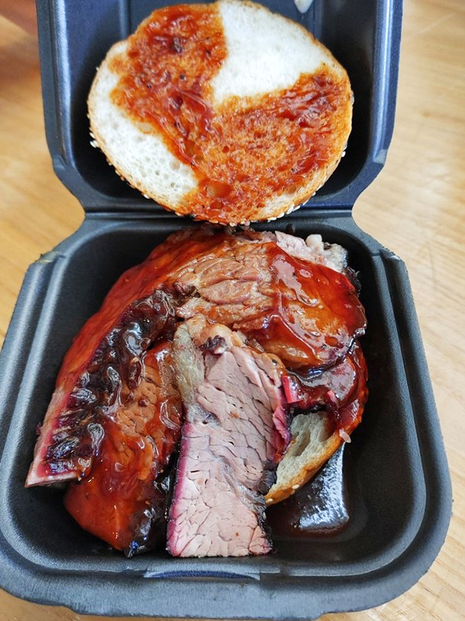 Brisket so tender it practically surrenders at the sight of your fork, with that telltale pink smoke ring that makes barbecue aficionados weak at the knees.