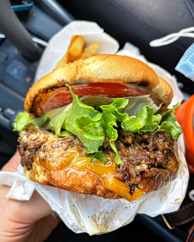 This isn't just a burger&mdash;it's a masterpiece of melted cheese, juicy beef, and fresh toppings that demands to be photographed before the first glorious bite.