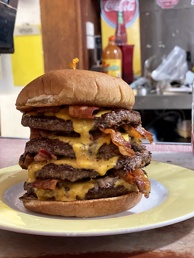 Behold the tower of power! This multi-patty masterpiece isn't just a burger&mdash;it's an engineering marvel with cheese as its structural support.