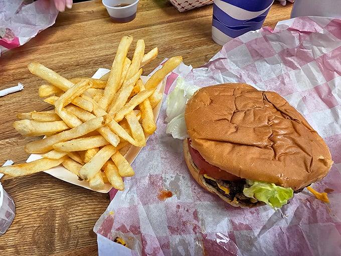 Behold the burger in its natural habitat: unpretentious, perfectly imperfect, and paired with golden fries that make those fancy truffle versions seem like unnecessary showing off.
