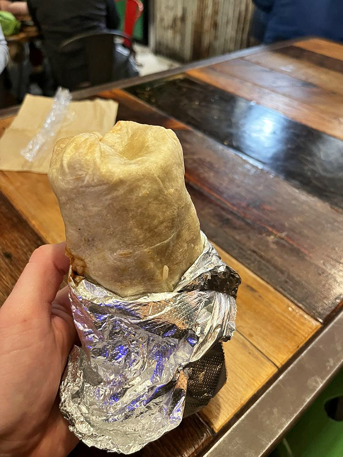 This isn't just a burrito; it's an architectural marvel wrapped in foil. The proper way to hold it? With both hands and great anticipation.