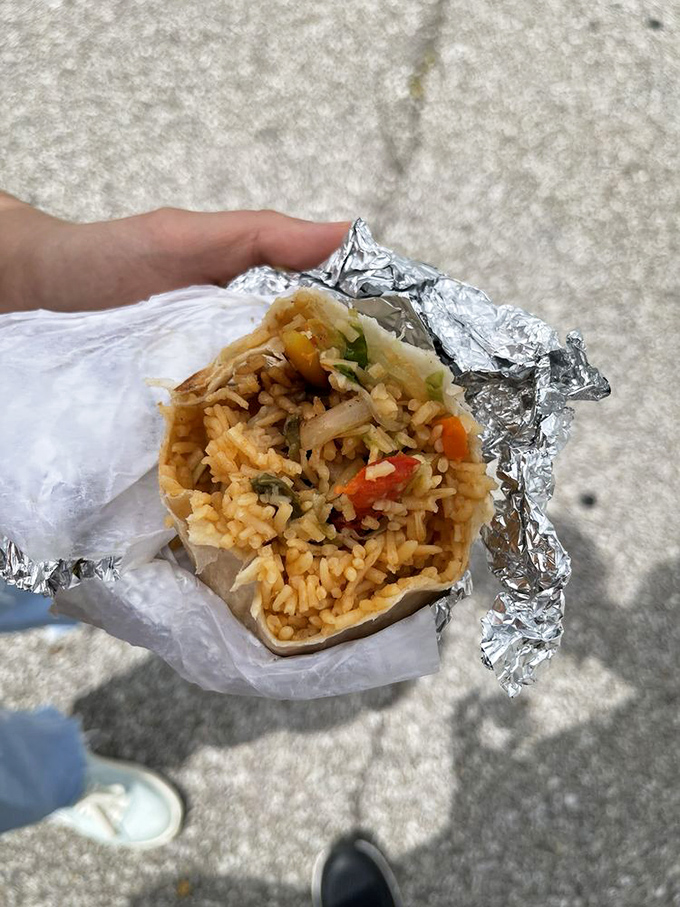 Behold the humble burrito in its natural habitat&mdash;wrapped in foil, stuffed with perfectly seasoned rice, and ready to make your lunch break legendary.