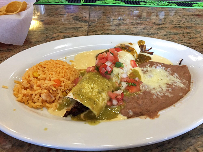 This enchilada plate isn't just dinner&mdash;it's a color wheel of Mexican flavors with green sauce, red rice, and refried beans creating edible artwork.