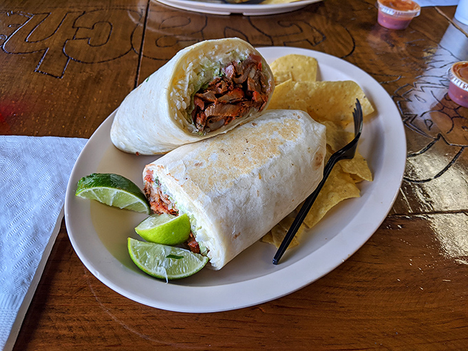 This isn't just a burrito; it's a masterclass in proper meat-to-filling ratio. The lime wedges aren't decorative &ndash; they're essential flavor keys.