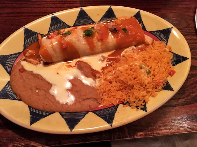 This burrito isn't just wrapped, it's embraced by sauce and accompanied by rice and beans like old friends at a reunion.