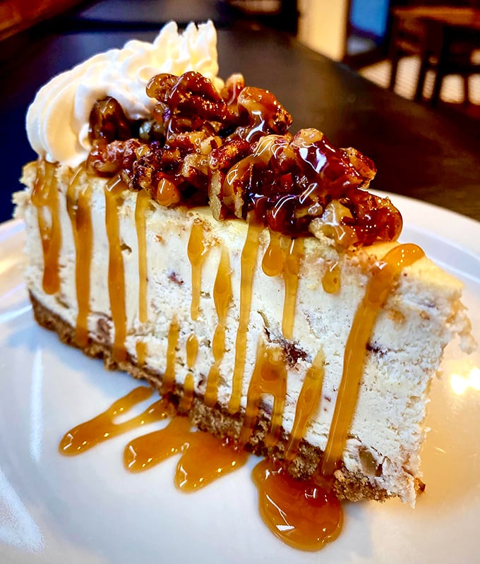 Behold the buttered pecan cheesecake&mdash;where caramel rivers cascade over creamy terrain, topped with pecan islands. Poetry on a plate.
