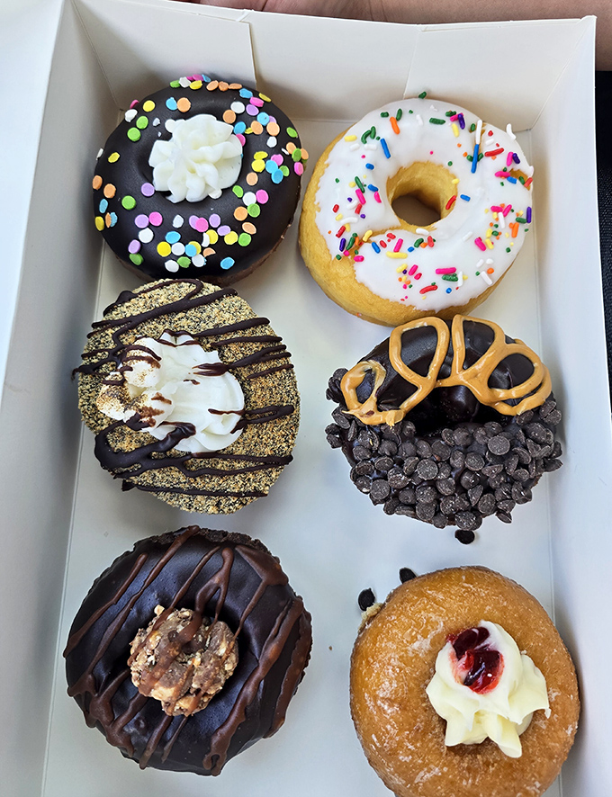 A box of edible art &ndash; each donut a masterpiece of flavor architecture, from chocolate-dipped masterpieces to cream-filled wonders.