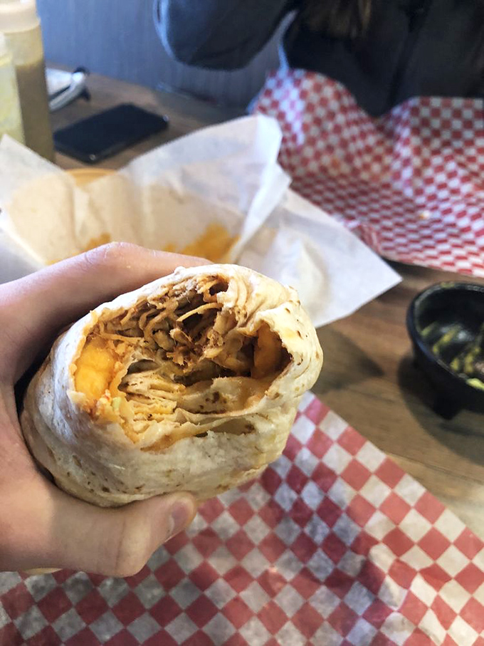 Behold the California burrito in all its stuffed glory! This handheld masterpiece packs more flavor in one bite than most restaurants manage in an entire meal.