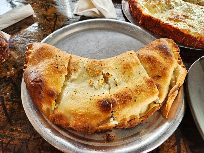 This isn't just a calzone &ndash; it's a golden-brown fortress protecting a treasure trove of cheese and fillings that's worth storming the castle for.