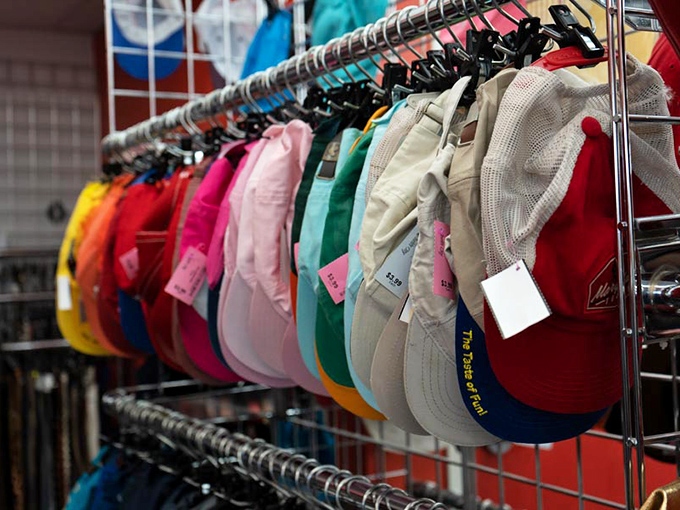 Baseball caps lined up like eager rookies on opening day. Each one carries someone's team loyalty, vacation memories, or just really good hair days.