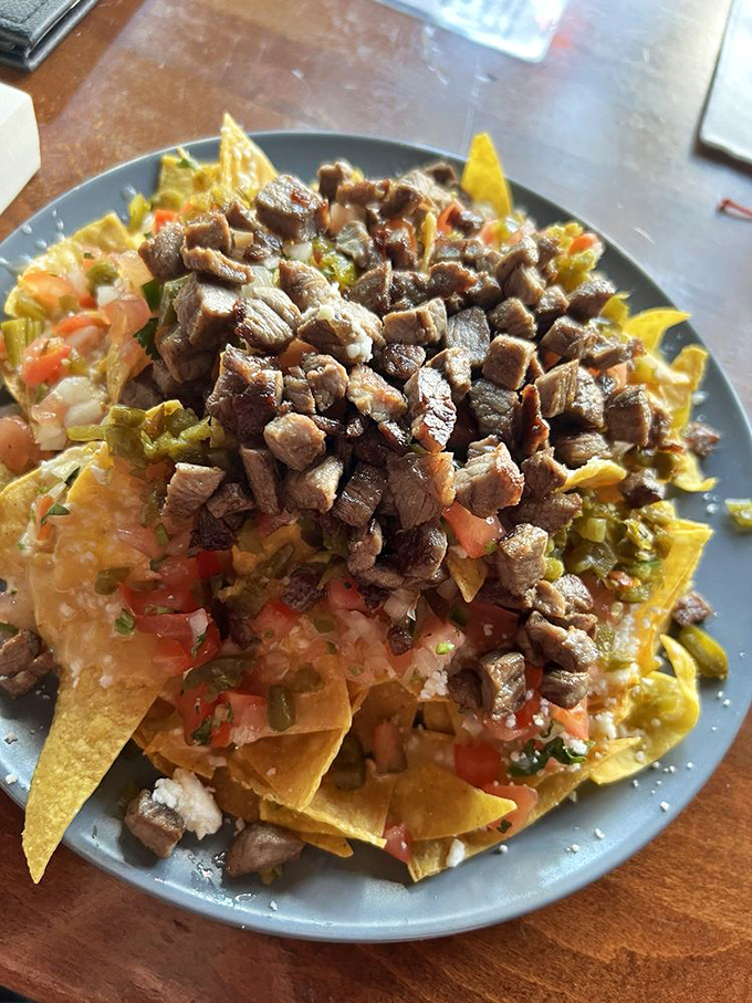 Carne asada nachos that solve the age-old problem of naked chips. Every triangle gets its fair share of perfectly seasoned beef and toppings.