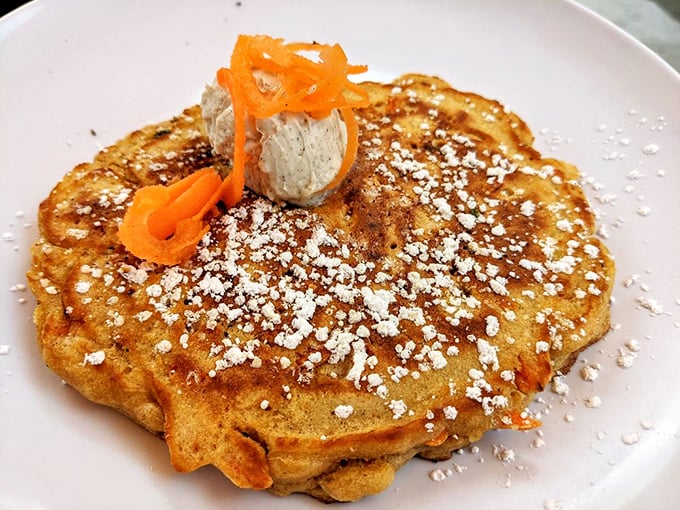 This isn't just a pancake &ndash; it's a golden canvas topped with powdered sugar snow and carrot ribbons that would make Bugs Bunny abandon his garden.