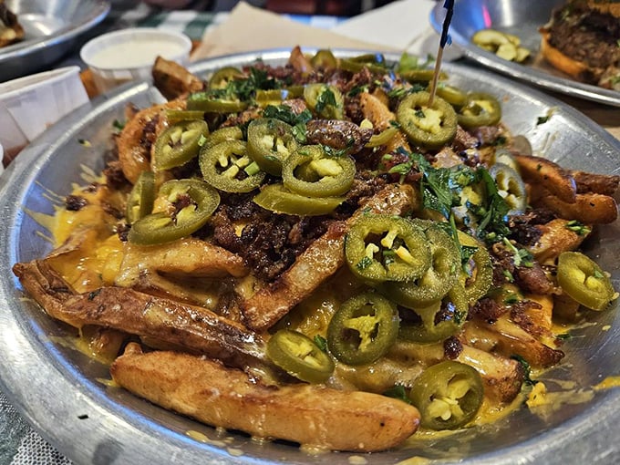 Not just fries, but a canvas for jalape&ntilde;o artistry. These hand-punched potatoes wearing melted cheese and peppers are what dreams are made of.