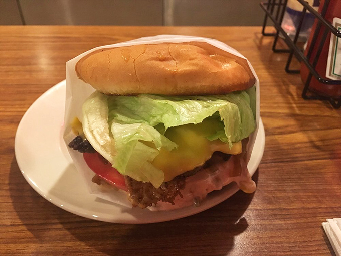 This isn't just a cheeseburger; it's edible nostalgia, wrapped in paper instead of pretension, waiting to transport you to simpler times.