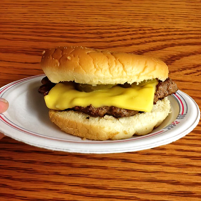 This isn't just a cheeseburger&mdash;it's a masterclass in simplicity. American cheese melts like a warm embrace over a perfectly seasoned patty.