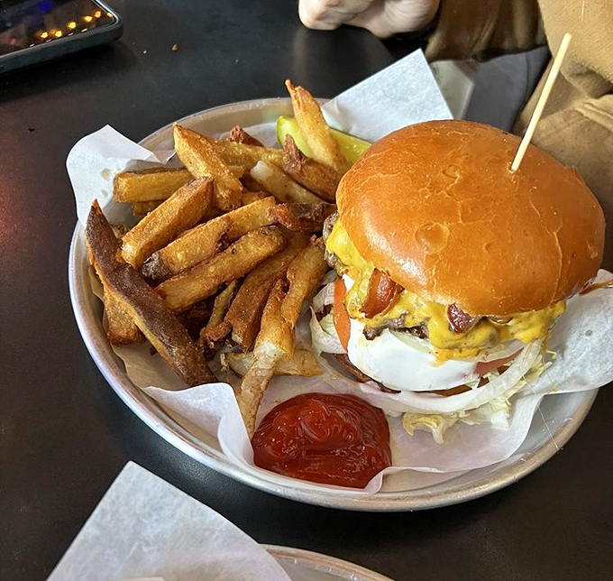 This isn't just a burger &ndash; it's an engineering marvel with a toothpick spire. The fries aren't sides; they're foundations for the impending food coma.