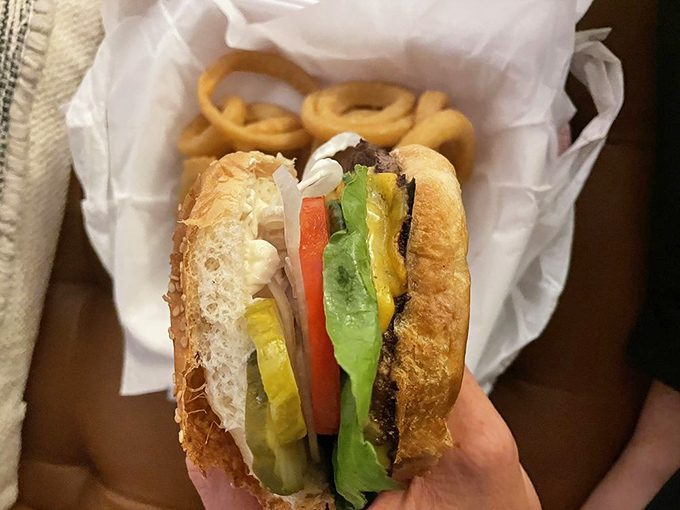 This isn't just a burger&mdash;it's architectural perfection. Note how the onion rings stand at attention, knowing they're in the presence of greatness.