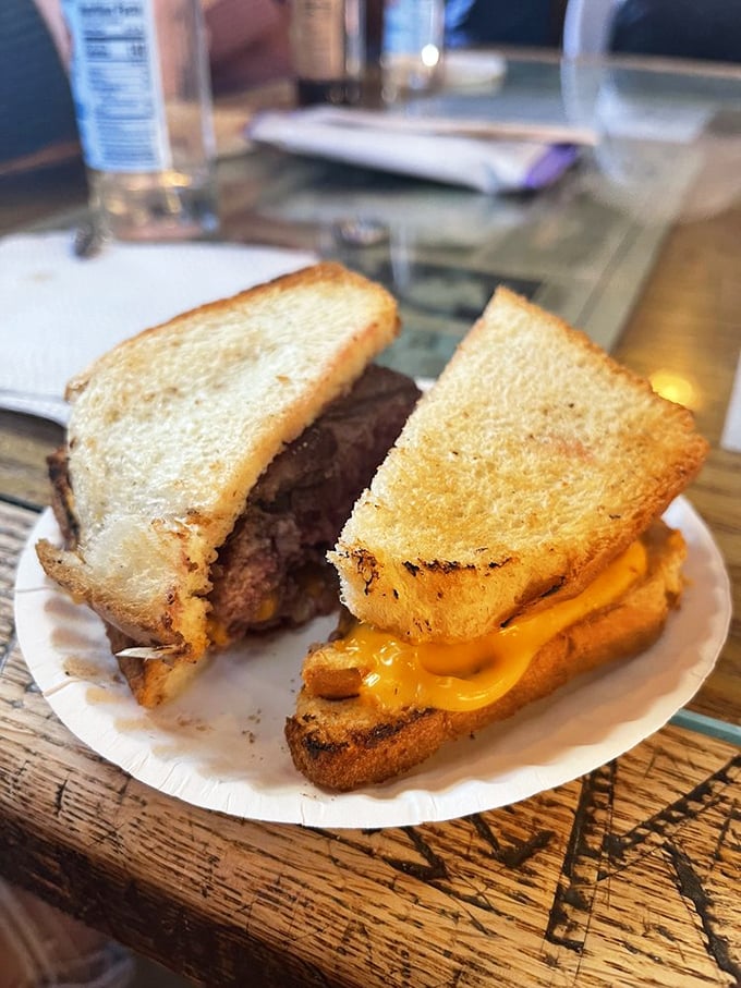 Burger architecture at its most honest&mdash;toast instead of buns, cheese that means business, and a patty cooked in a contraption that looks like it could power a steam locomotive.