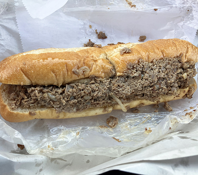 Behold the star of the show – a perfectly proportioned cheesesteak where thinly sliced beef meets melted cheese in a harmony that makes Philadelphians nervous.