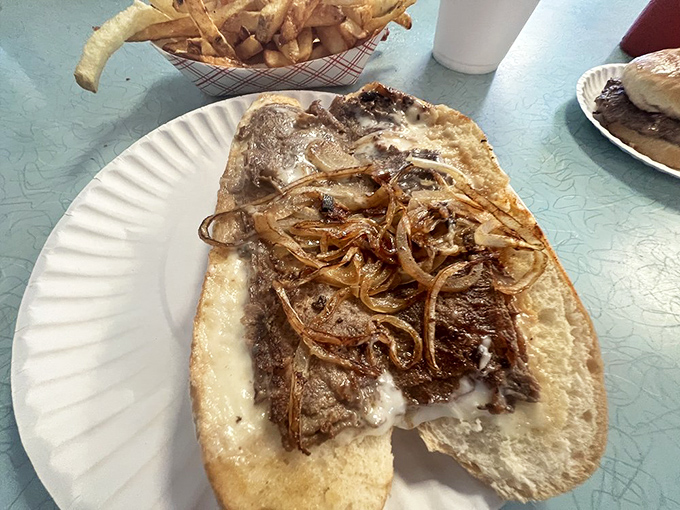 A proper cheesesteak isn't about fancy ingredients&mdash;it's about perfect balance. This beauty delivers with caramelized onions and melted cheese that binds everything in harmony.