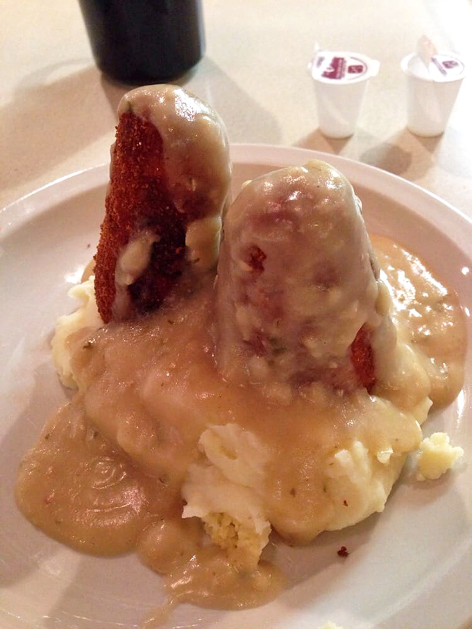 Chicken croquettes: where comfort food meets architectural achievement. These golden-brown towers of tender chicken stand proudly in a lake of velvety gravy.