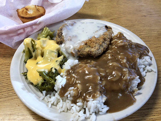 Comfort on a plate! The chicken fried steak swimming in gravy alongside cheese-draped broccoli is the culinary equivalent of a warm hug from grandma.