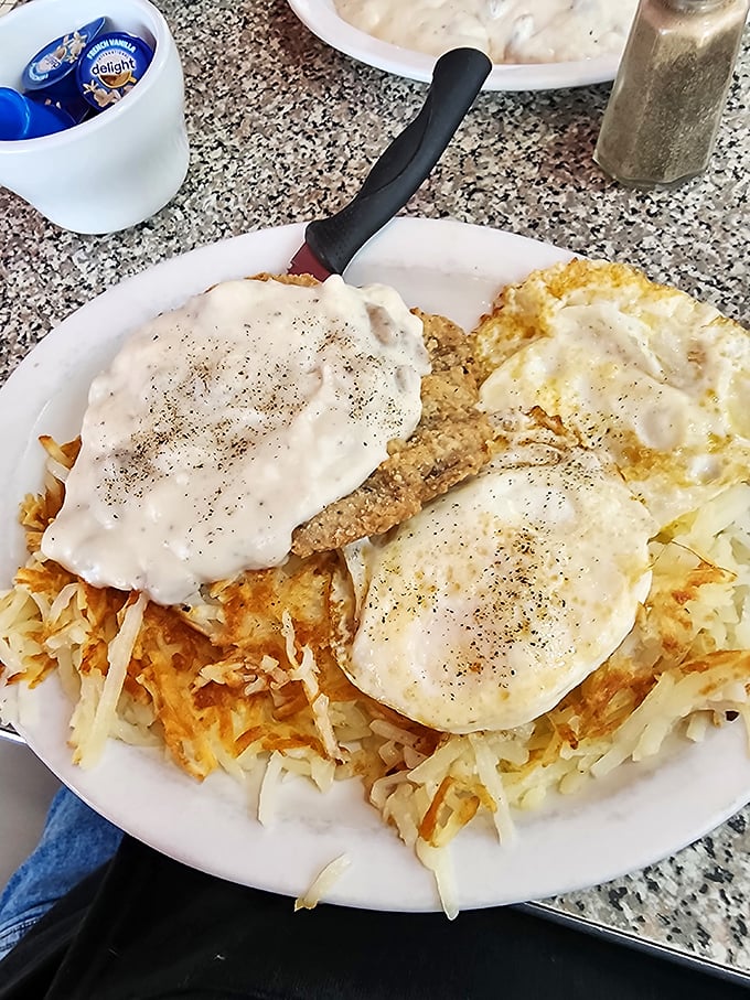 This isn't just chicken fried steak&mdash;it's a masterpiece of crispy, creamy comfort crowned with pepper-speckled gravy and nestled beside golden hash browns.