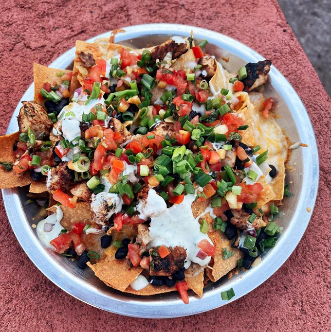 These nachos aren't just a dish&mdash;they're an architectural achievement of crispy chips, fresh toppings, and enough cheese to make Wisconsin nervous.