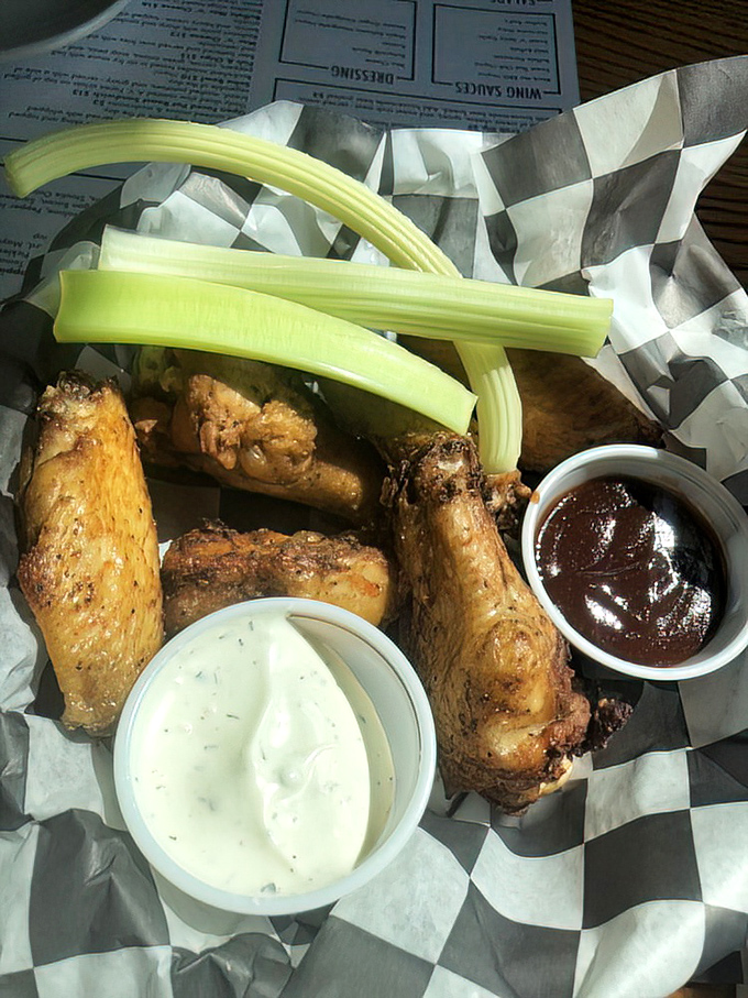 These wings aren't just served; they're presented like the culinary rock stars they are, complete with blue cheese dressing that deserves its own fan club.