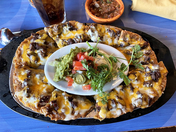 These nachos aren't just arranged&mdash;they're architected, with each chip supporting its own perfect ecosystem of toppings and that glorious central guacamole island.