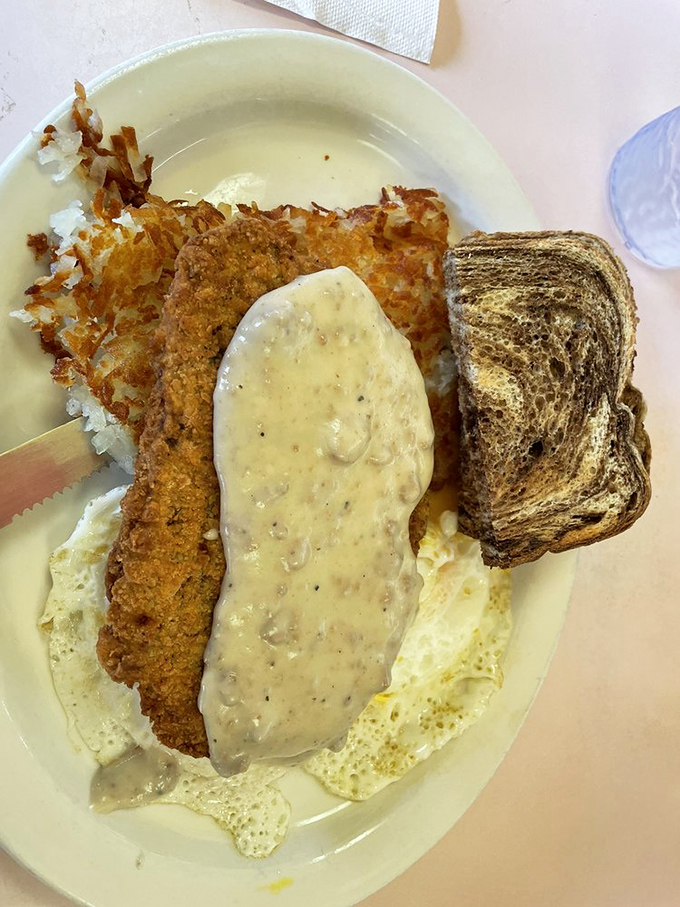 This chicken fried steak isn't just food&mdash;it's therapy on a plate, wearing a gravy overcoat and accompanied by perfect hash browns.