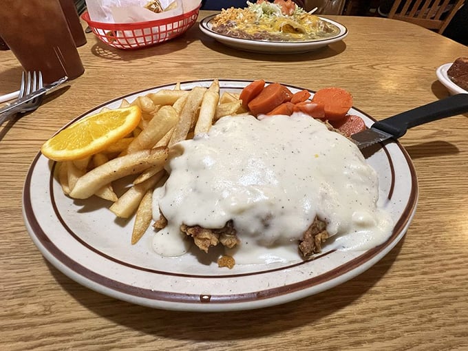 Behold, the star of our show&mdash;chicken fried steak smothered in peppery gravy with fries and veggies that know their supporting role perfectly.