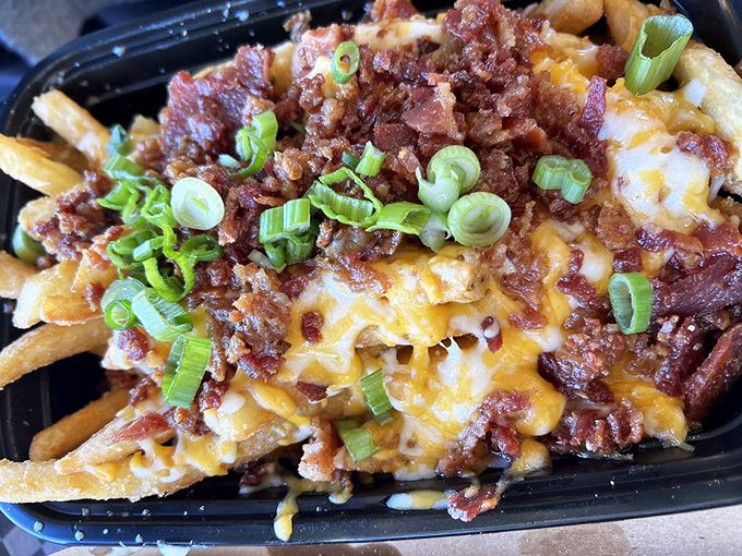 The legendary chili cheese fries in their full glory&mdash;crispy potatoes smothered in savory chili, melted cheese, and those green onions adding just enough virtue to justify the indulgence.