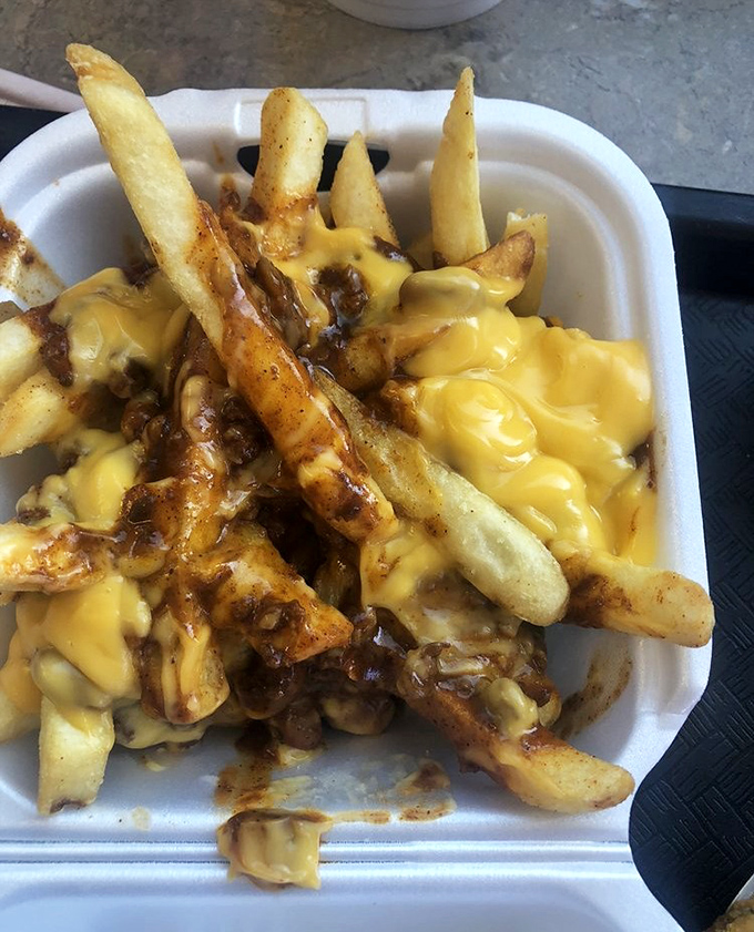 Behold the holy trinity of comfort food: golden fries, savory chili, and cheese that stretches like your elastic waistband will after eating this masterpiece.