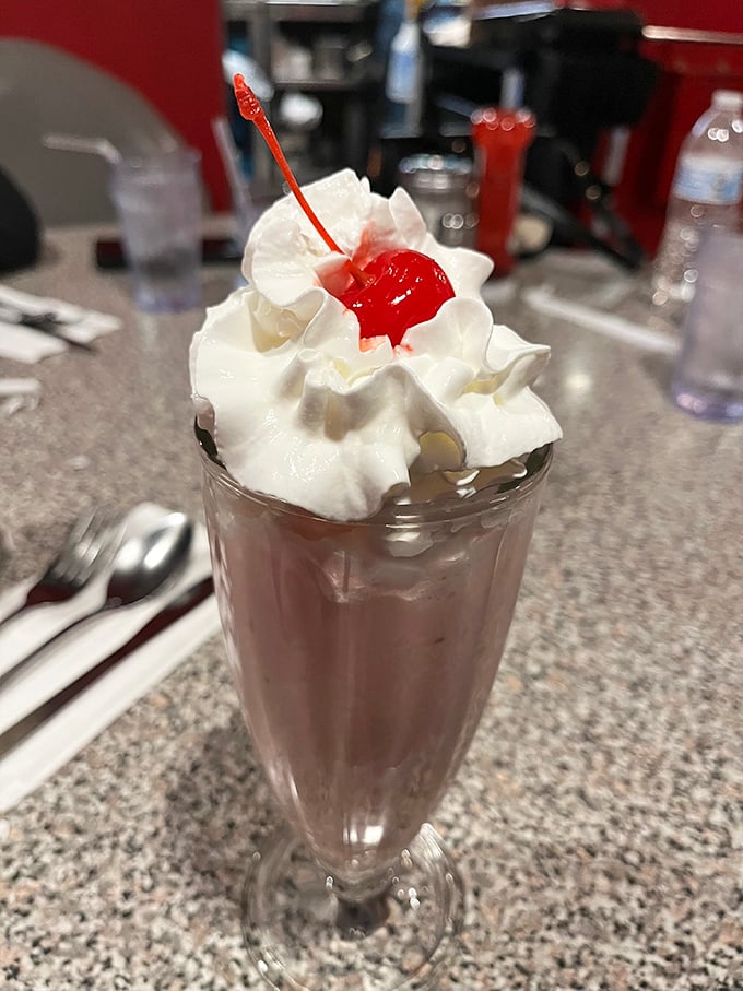 Chocolate milkshake perfection topped with whipped cream and a cherry - because some traditions never go out of style.