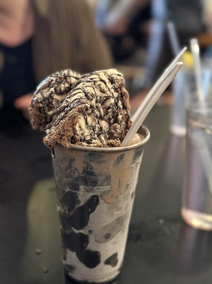 This isn't just a chocolate shake &ndash; it's a structural engineering marvel that somehow balances decadence and nostalgia in the same metal cup.