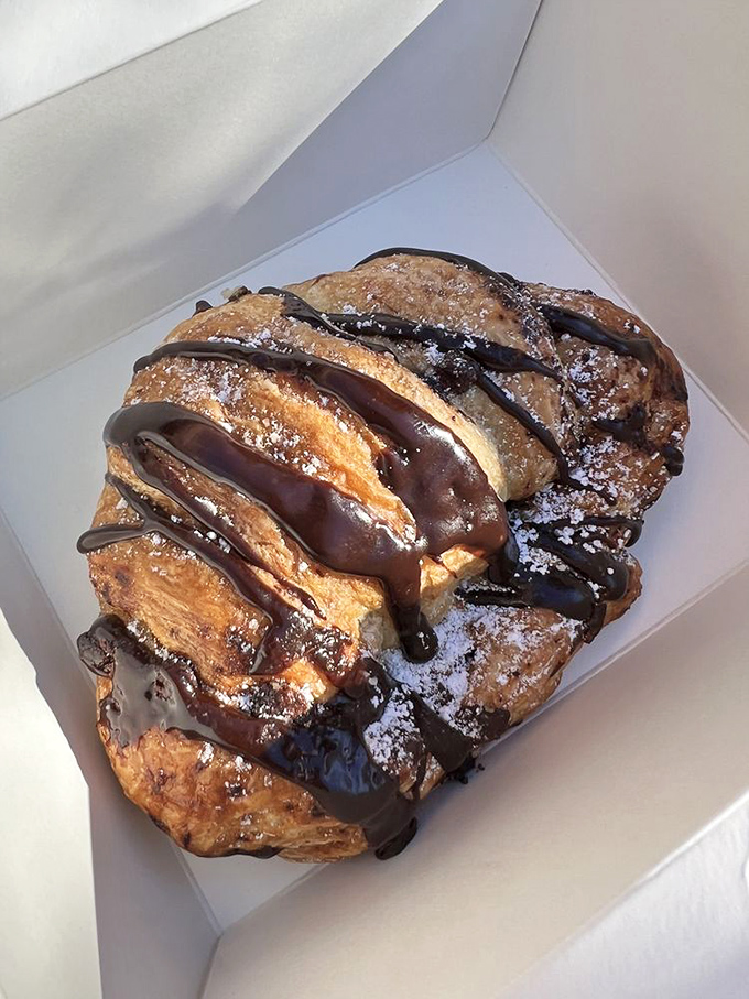 Chocolate croissant nirvana! Flaky, buttery layers drizzled with chocolate that would make a French pastry chef weep with joy and reach for seconds.