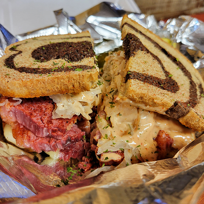 Sandwich architecture at its finest! Layers of pink corned beef, tangy sauerkraut, and melted Swiss create a masterpiece between perfectly grilled rye.