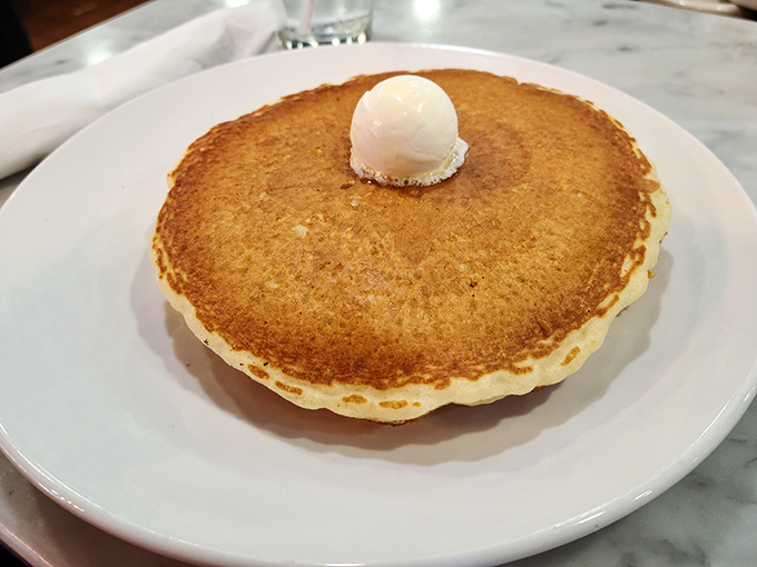 The pancake that launched a thousand road trips. That melting pat of butter slowly creating a golden pool is breakfast's version of performance art.