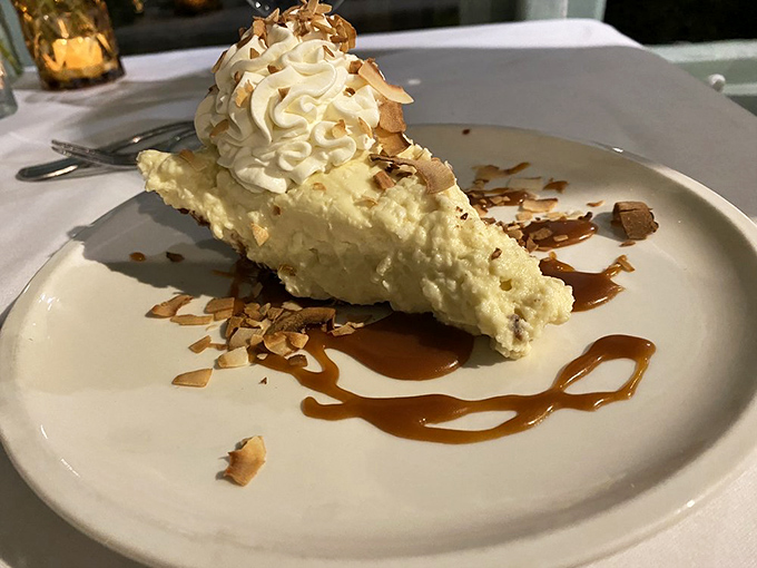 Coconut cream pie that looks like a cloud decided to become dessert, complete with toasted almonds for textural drama.