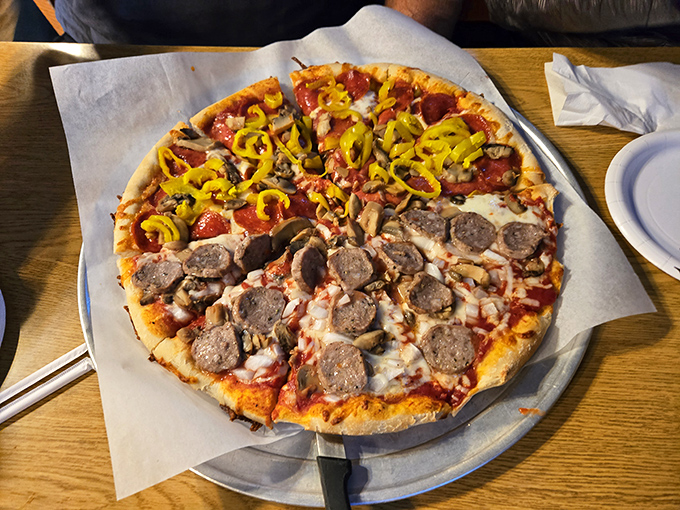 Pizza perfection divided down the middle &ndash; sausage for the pragmatist, banana peppers for the adventurer. Like having two vacations on one plate.