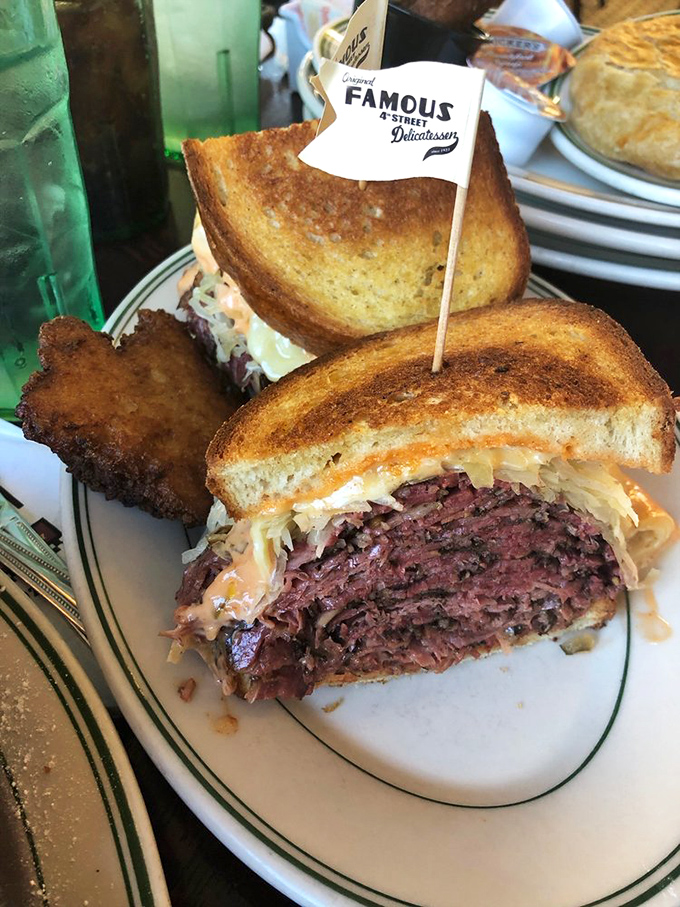Meet the Reuben that launched a thousand food pilgrimages. Corned beef stacked so high it should have its own altitude warning&mdash;pure sandwich architecture.