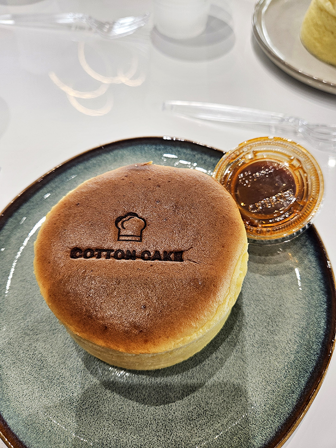 Meet the star of the show: a golden-topped Japanese cheesecake branded with love and served with a side of caramel that's practically begging to be drizzled.