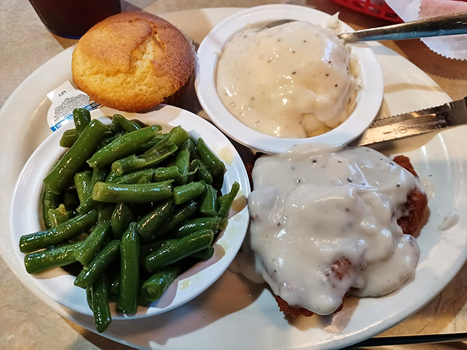 The Country Fried Steak arrives with green beans so vibrant they could photobomb a fashion shoot, while that cream gravy whispers, "Naptime is coming."