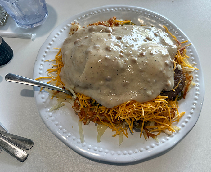 The Cowboy Bennies don't mess around - a breakfast rodeo of hash browns, cheese, and sausage gravy that would make John Wayne weep.