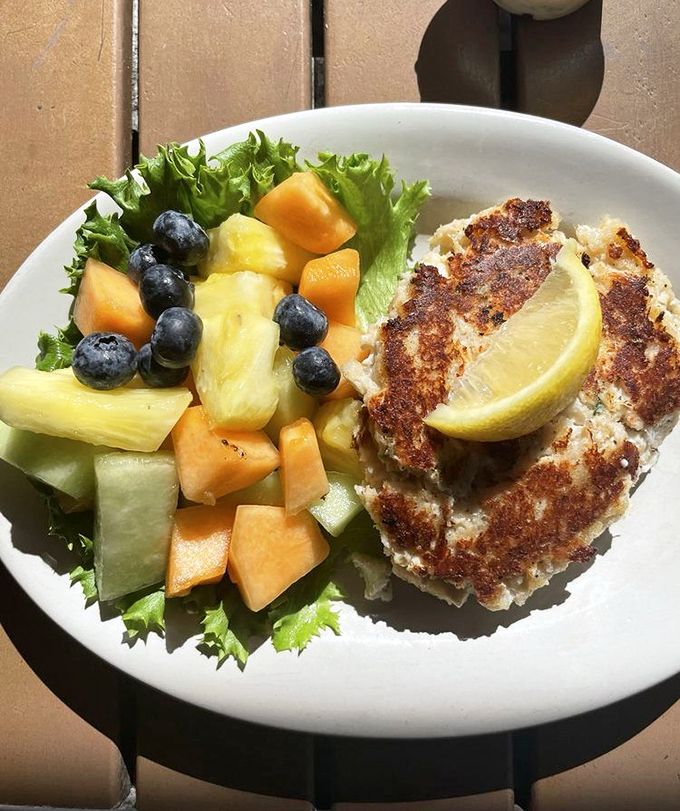 The star of the show in all its golden-crusted glory. This crab cake isn't just a dish—it's the reason GPS systems were invented.